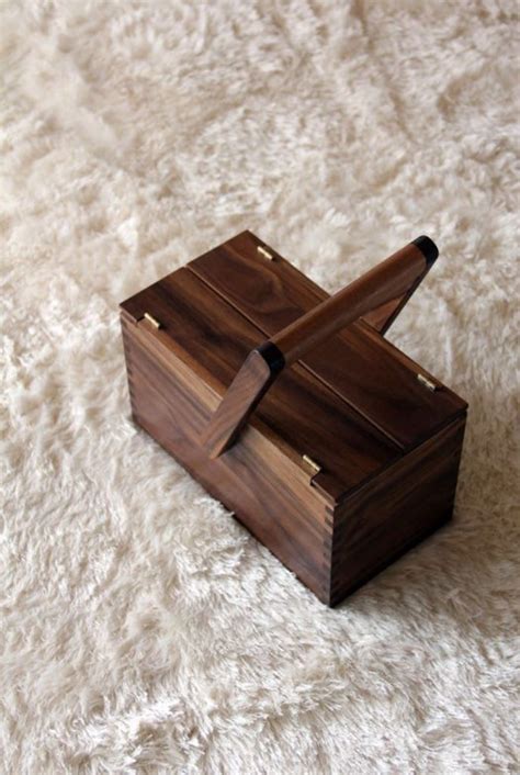 A Wooden Box Sitting On Top Of A Fluffy White Carpet Next To A Knife Holder