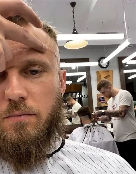 A Man Getting His Hair Cut In A Barber Shop