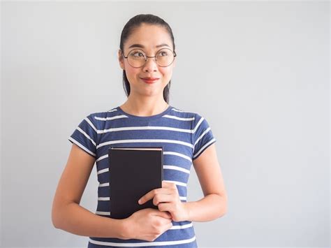 Premium Photo Nerdy Asian Woman Smiles And Holding A Good Book