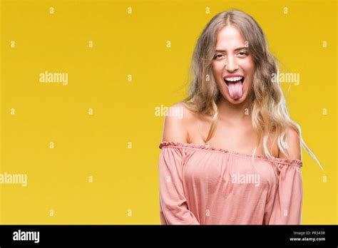 Beautiful Young Blonde Woman Over Isolated Background Sticking Tongue Out Happy With Funny