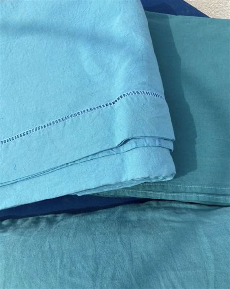 Two Blue Sheets Are Laying On Top Of Each Other In The Same Bedding Set
