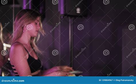Attractive Long Haired Blonde Girl Putting On Her Favorite Music On Phone And Ready For Training