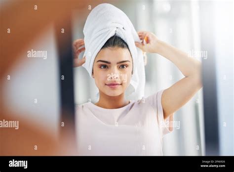 Lets Get This Fresh Day Started A Beautiful Young Woman Admiring Her Skin In The Mirror At Home