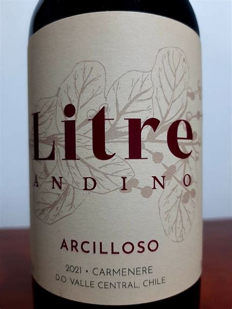 A Bottle Of Wine Sitting On Top Of A Wooden Table