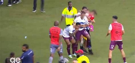 Torcedor criança no colo invade campo e agride jogador durante