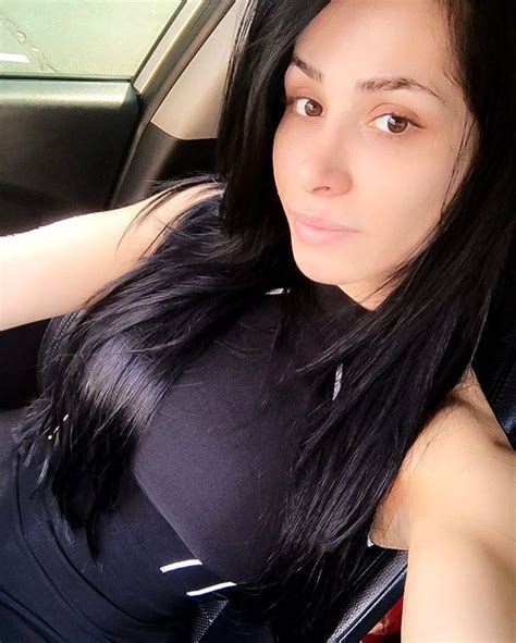 A Woman Sitting In The Back Seat Of A Car With Her Hand On Her Hip