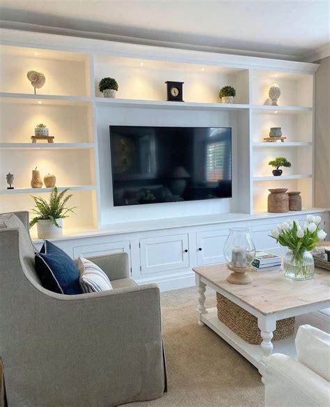 A Living Room Filled With Furniture And A Flat Screen Tv Mounted On A