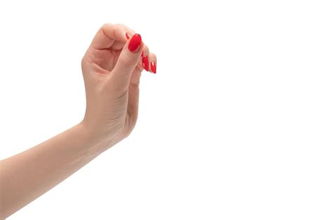 Premium Photo Woman Hand With Red Nails Holding Something