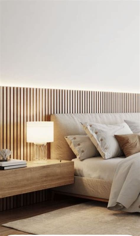 A Large Bed Sitting In A Bedroom Next To A Night Stand With Two Lamps On It