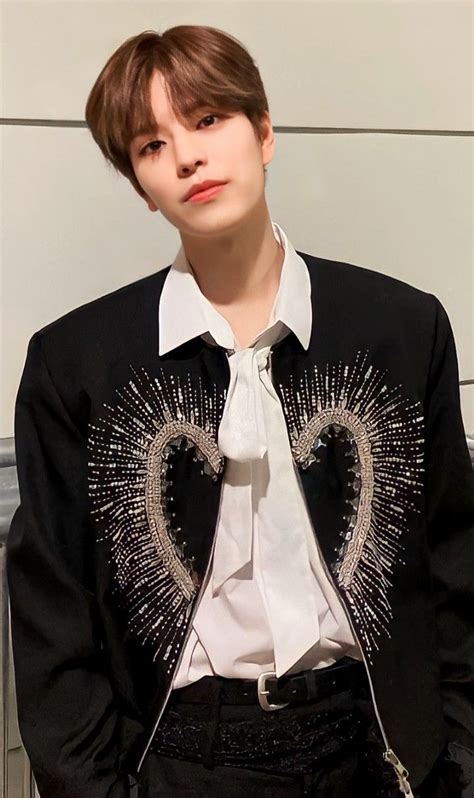 A Person Wearing A Black Jacket And White Shirt