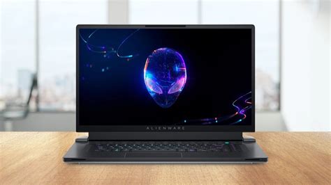 An Open Laptop Computer Sitting On Top Of A Wooden Table