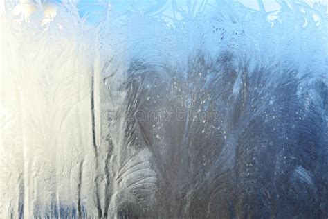 Frozen Winter Window With Shiny Ice Frost Pattern Texture Stock Photo