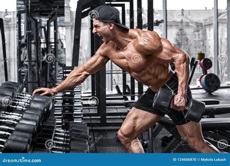Muscular Man Working Out In Gym Doing Exercises For Back Single Arm