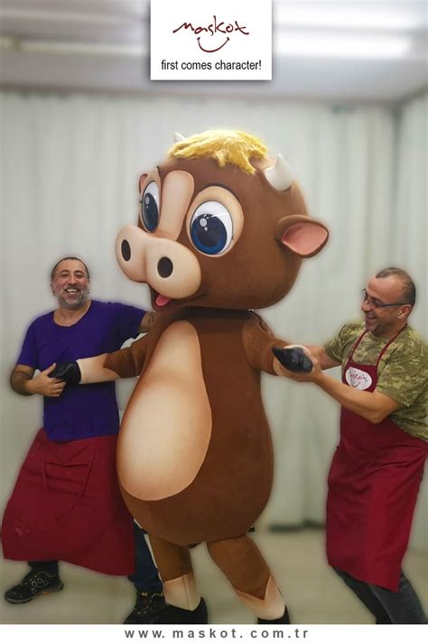 Two Men In Aprons Standing Next To A Mascot