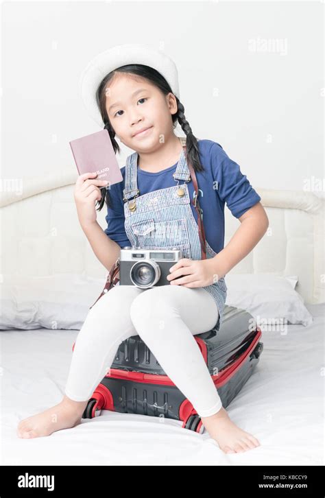 Asian Cute Girl Show Passport And Sit On Suitcase Prepare Or Ready To