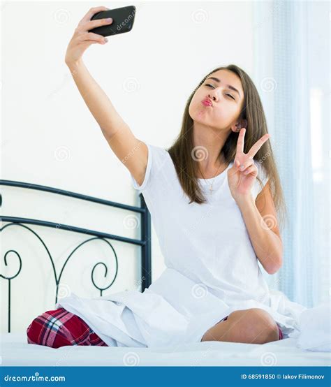 Happy Female Teenager Doing Selfie In Bed Stock Photo Image 68591850