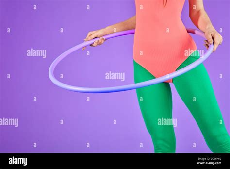 Half View Of Unrecognizable Fitness Woman Standing And Holding Hula Hoop Doing Aerobics