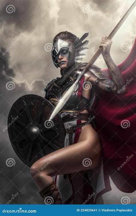 Divine Amazon With Spear And Shield Against Heaven Background Stock