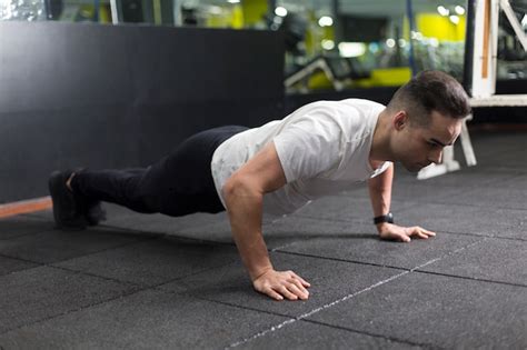 Joven Musculoso Haciendo Ejercicio En El Gimnasio Foto Premium