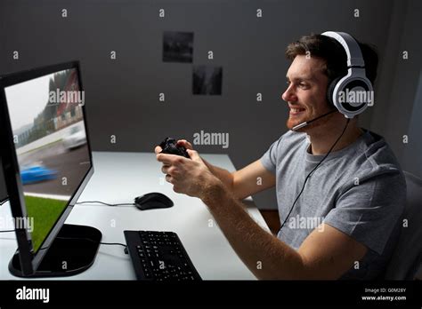 Man In Headset Playing Computer Video Game At Home Stock Photo Alamy
