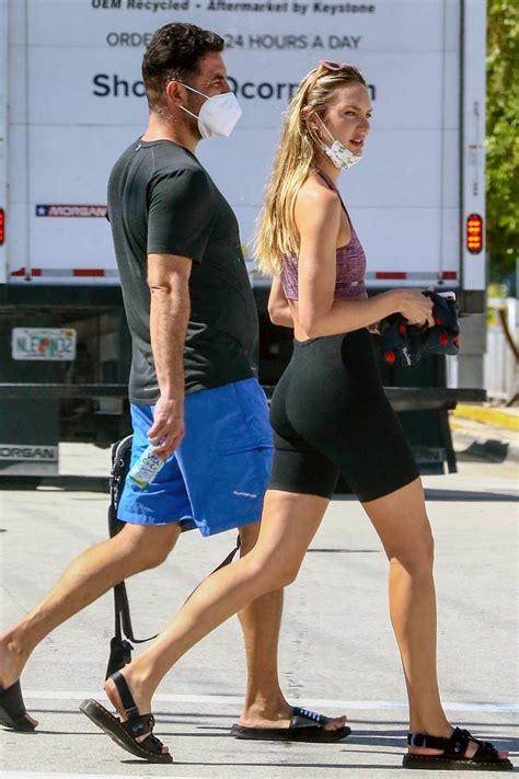 Candice Swanepoel Flaunts Her Toned Figure In A Crop Top And Legging Shorts During A Stroll In