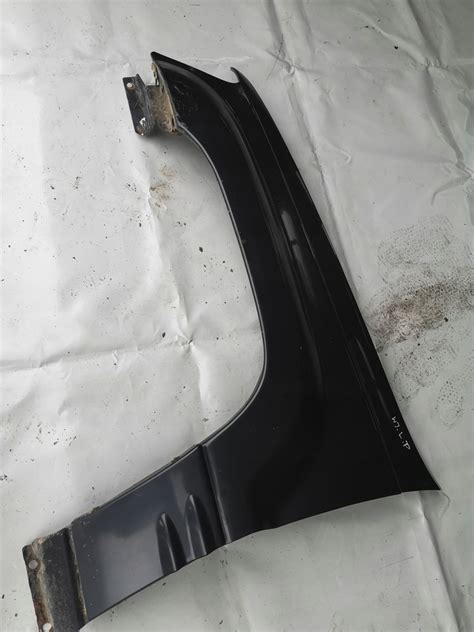 JEEP GRAND CHEROKEE WJ BŁOTNIK LEWY PRZÓD CZARNY 9779323621