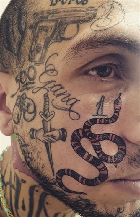 A Man With Tattoos On His Face And Neck