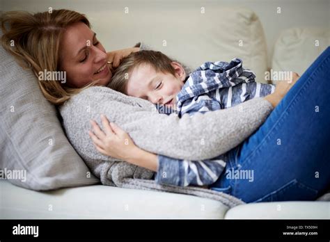 Mother And Son Cuddling On The Couch Stock Photo Alamy