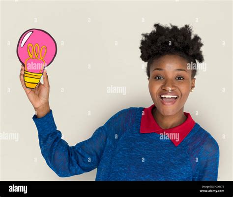 African Descent Woman Smiling And Holding Light Bulb Stock Photo Alamy