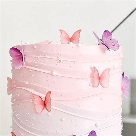There Is A Pink Cake With Butterflies On It