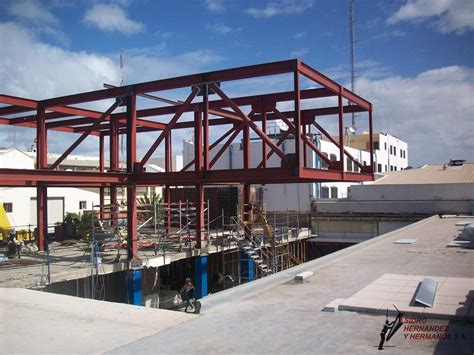 A Building Under Construction With Scaffolding On The Roof