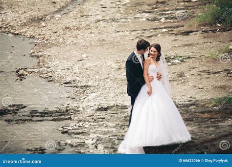 Elegant Gentle Stylish Groom And Bride Near River With Stones Wedding Couple In Love Stock
