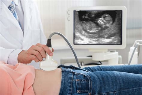 Doctor Moving Ultrasound Probe On Pregnant Woman Inside Mobile Ob Gyn