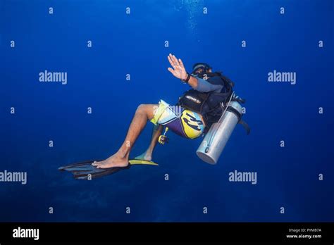 Underwater Surfing Scuba Diver Embarked On Fins And Rides Them In Strong Current Like Surfboard