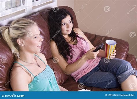 Two Girls Sitting On The Sofa Watching A Movie Stock Image Image Of Beautiful Cute 15991765