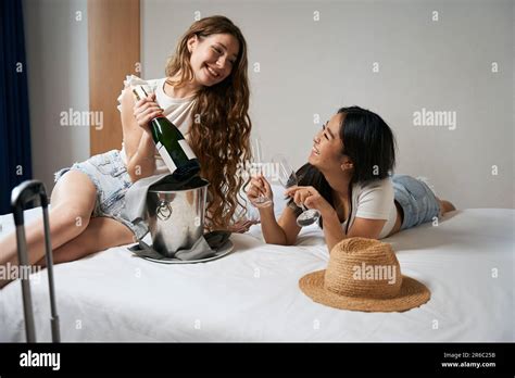 Two Friends Celebrating A Trip In A Hotel Room Stock Photo Alamy