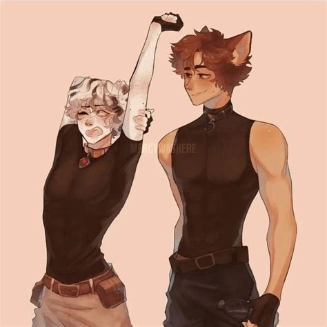 Two People Are Standing Next To Each Other With Their Arms In The Air