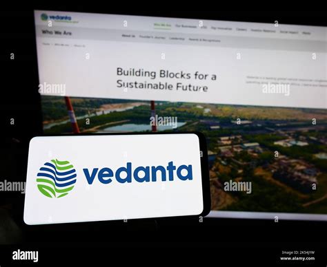Person Holding Smartphone With Logo Of Indian Mining Company Vedanta