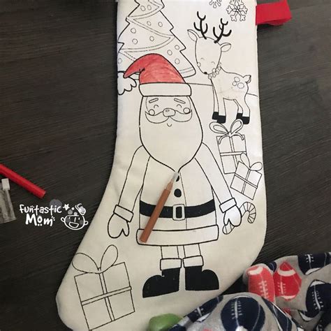 An Oven Mitt Decorated With Santa Clause And Reindeers Along With