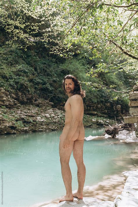 Naked Man Preparing To Swim In River By Stocksy Contributor Alina