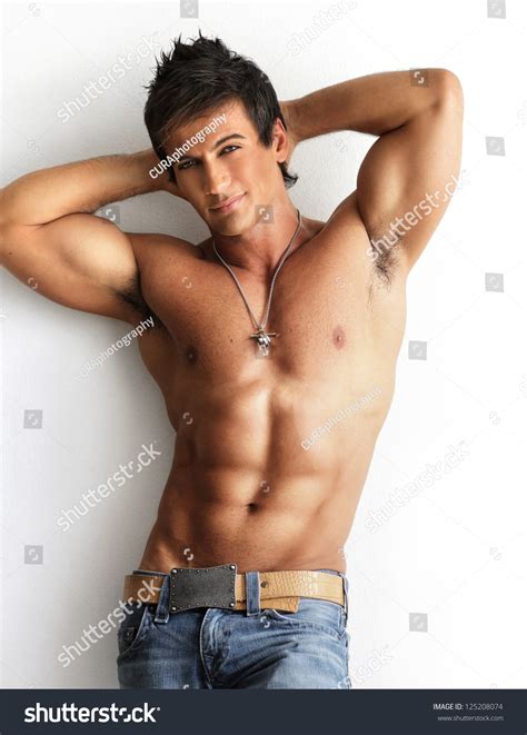 Portrait Of A Well Built Shirtless Muscular Male Model Against White