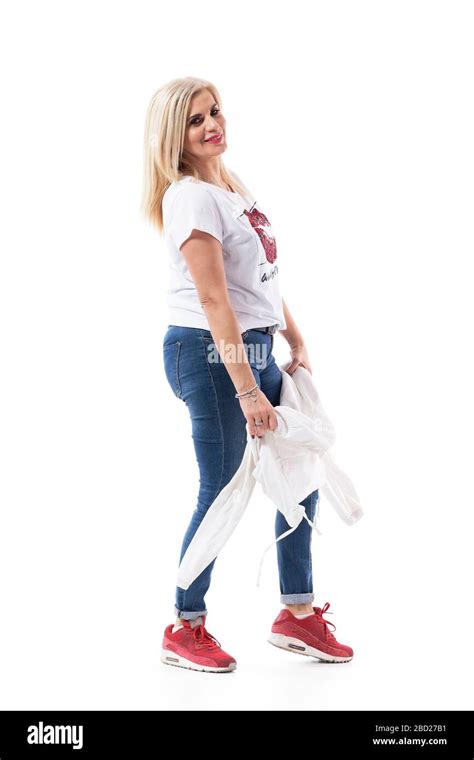 Side View Of Candid Happy Middle Aged Woman Undressing Shirt And Posing