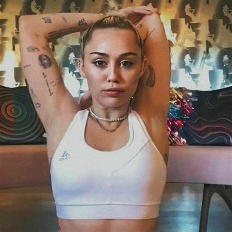 A Woman With Tattoos On Her Arms And Chest