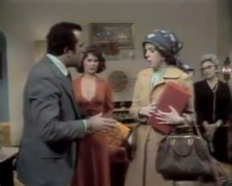 A Group Of People Standing Around Each Other In Front Of A Man Holding