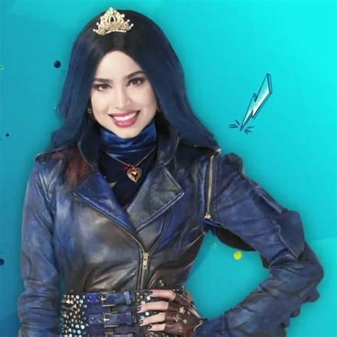 A Woman With Blue Hair Wearing A Leather Jacket And Holding Her Hands On Her Hips