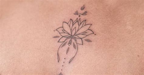 Ornamental Lotus Flower Tattoo Located On The Chest