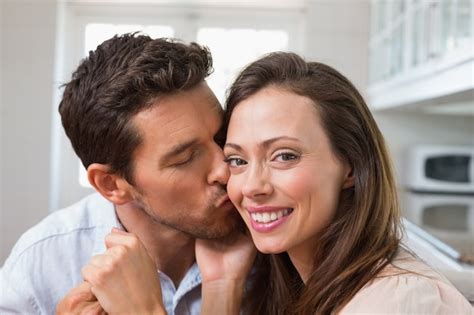 Premium Photo Loving Man Kissing Woman On Cheek At Home