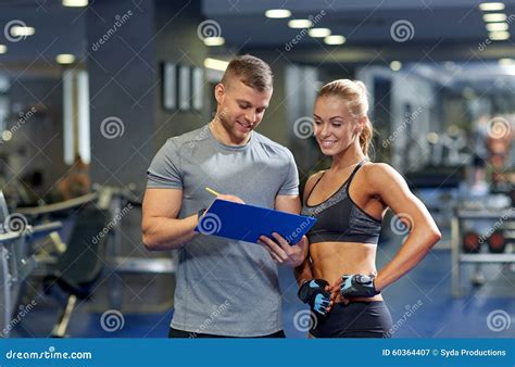 Smiling Young Woman With Personal Trainer In Gym Stock Image Image Of Healthy Happy 60364407