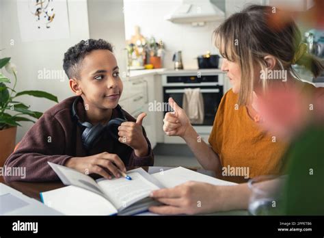 Mother Helping Son With Homework Stock Photo Alamy