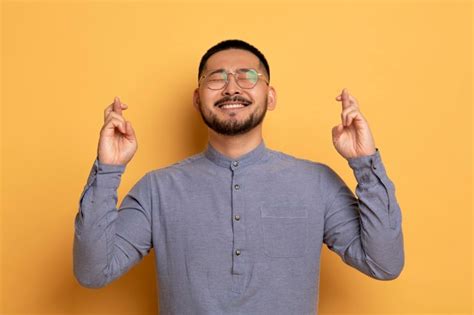 Premium Photo Making Wish Portrait Of Cheerful Asian Man Keeping His